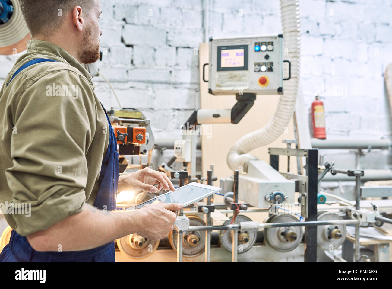 Worker Using Modern Machine at Factory Stock Photo - Alamy