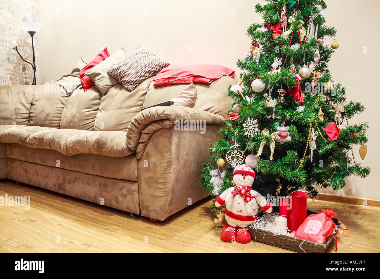 Festive holiday interior, Christmas tree and sofa Stock Photo - Alamy