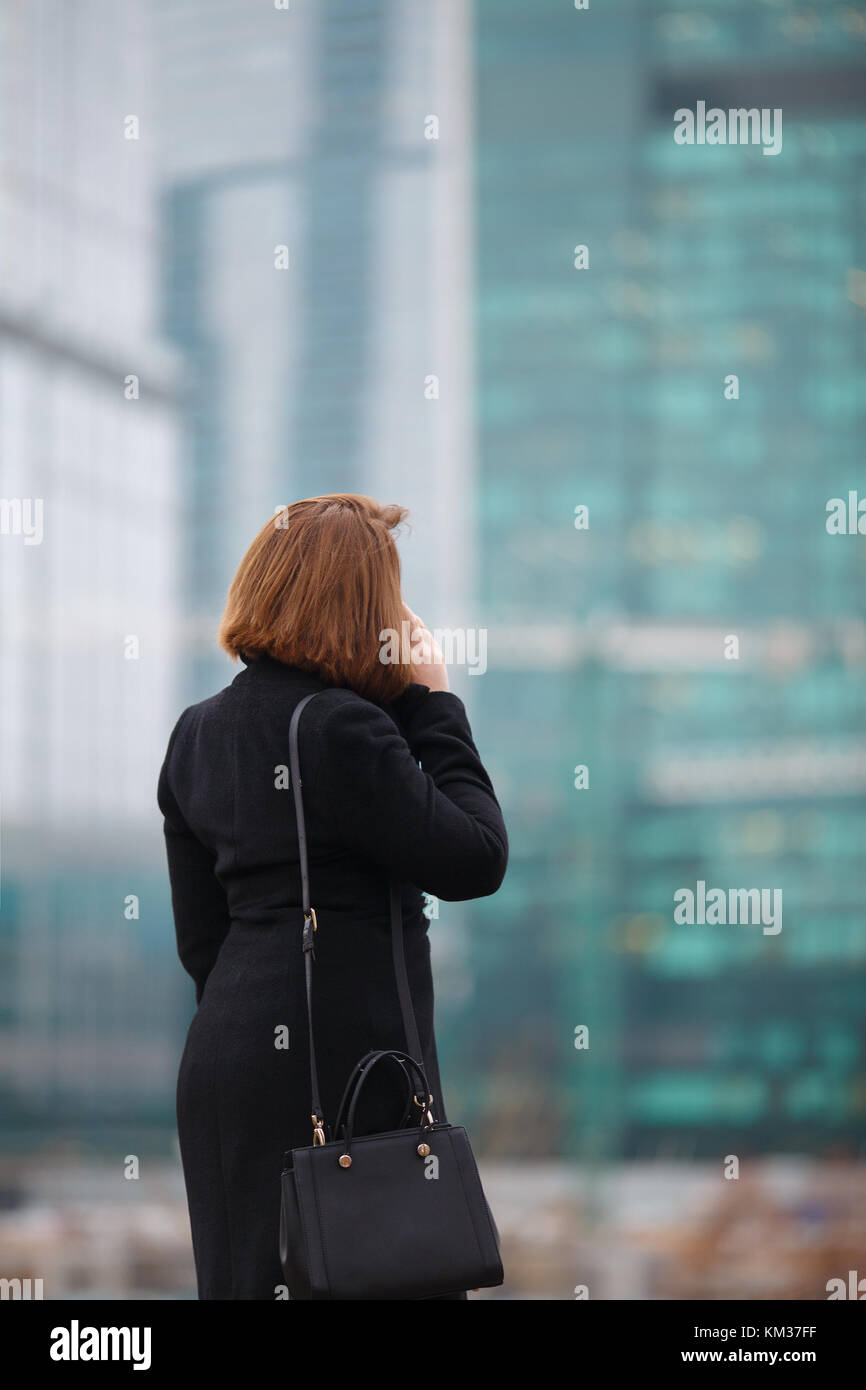 Photo from back of woman in black coat Stock Photo - Alamy
