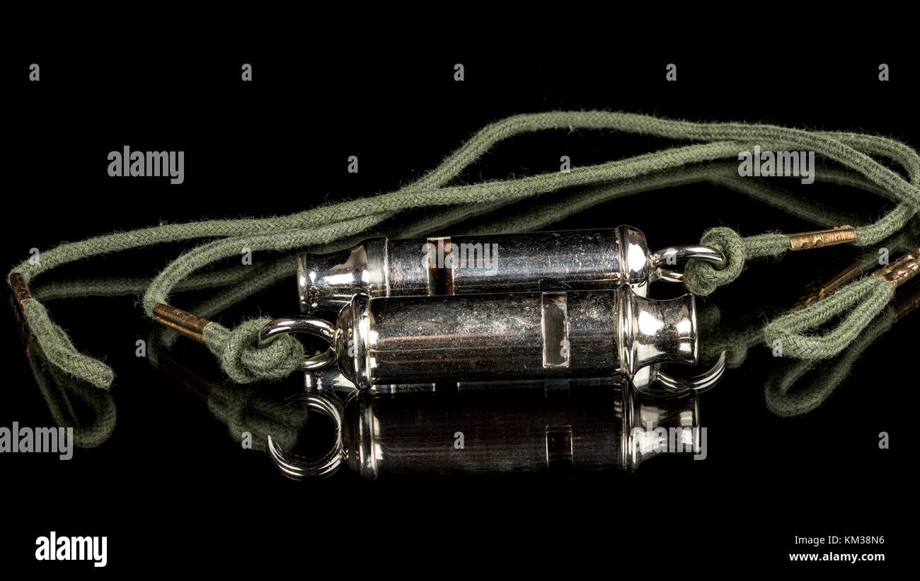 Pair of silver colored metal whistles with green neckstraps Stock Photo ...