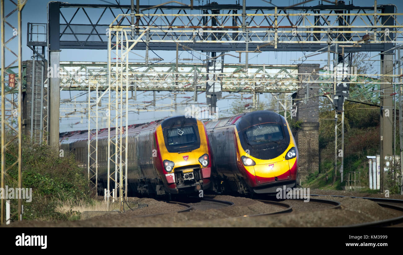 A Class 221 Voyager with a Euston to Holyhead service passes Class 390 ...