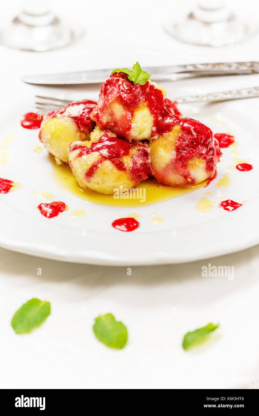 Traditional czech blueberry dumplings with raspberry coulis Stock Photo ...