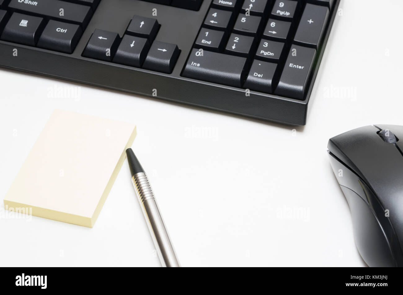 Computer keyboard and mouse, pen, Yellow sticky note isolated on white ...