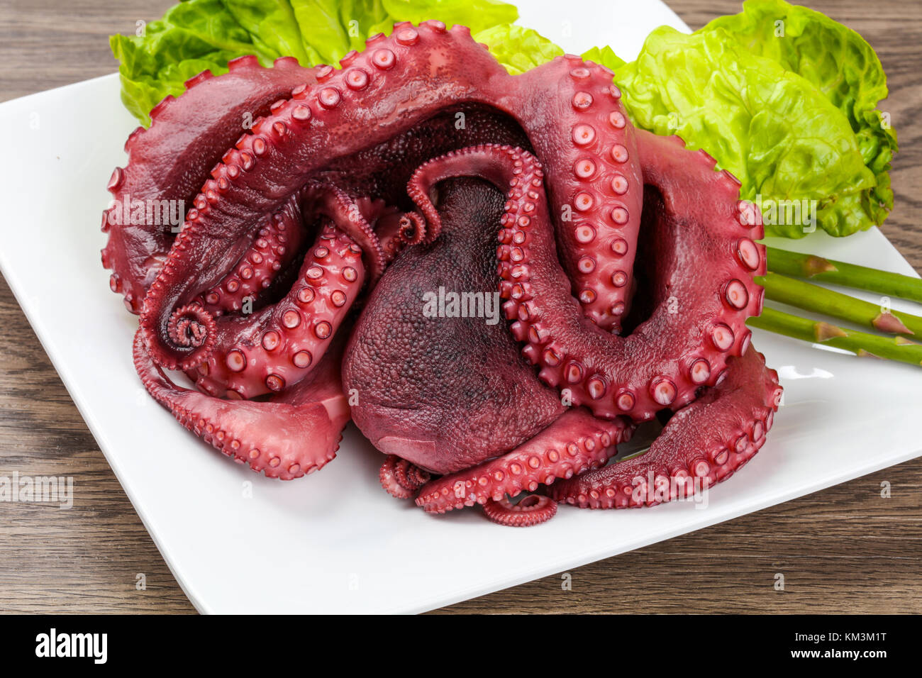 Boiled octopus ready for eat with salad leaves Stock Photo - Alamy