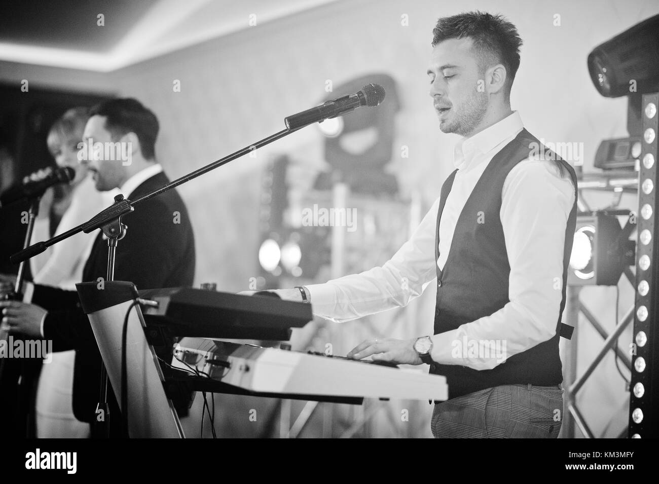 Musicial music live band performing on a stage with different lights ...
