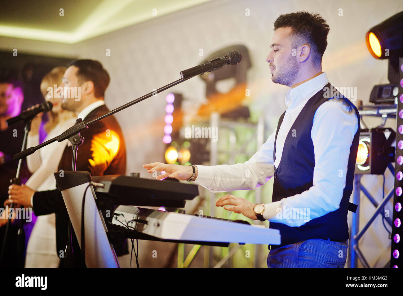 Musicial music live band performing on a stage with different lights ...
