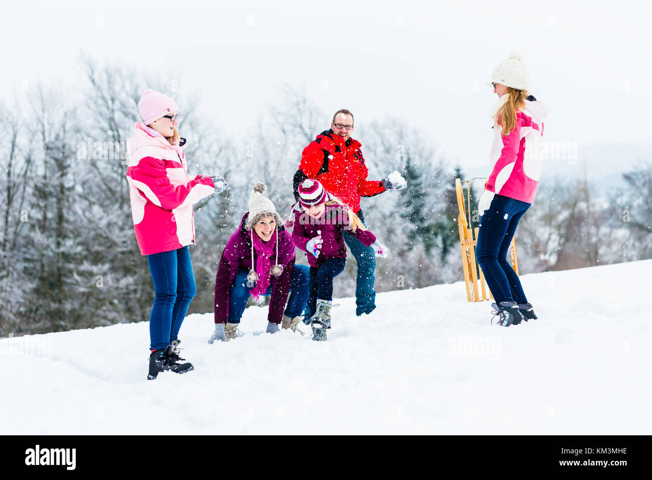 Happy kids playing snowball fight hi-res stock photography and images ...