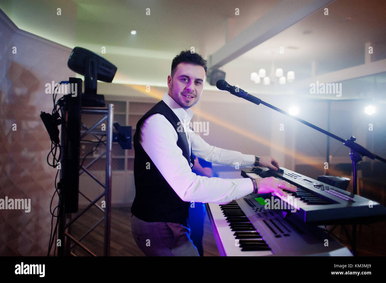 Musicial music live band performing on a stage with different lights ...
