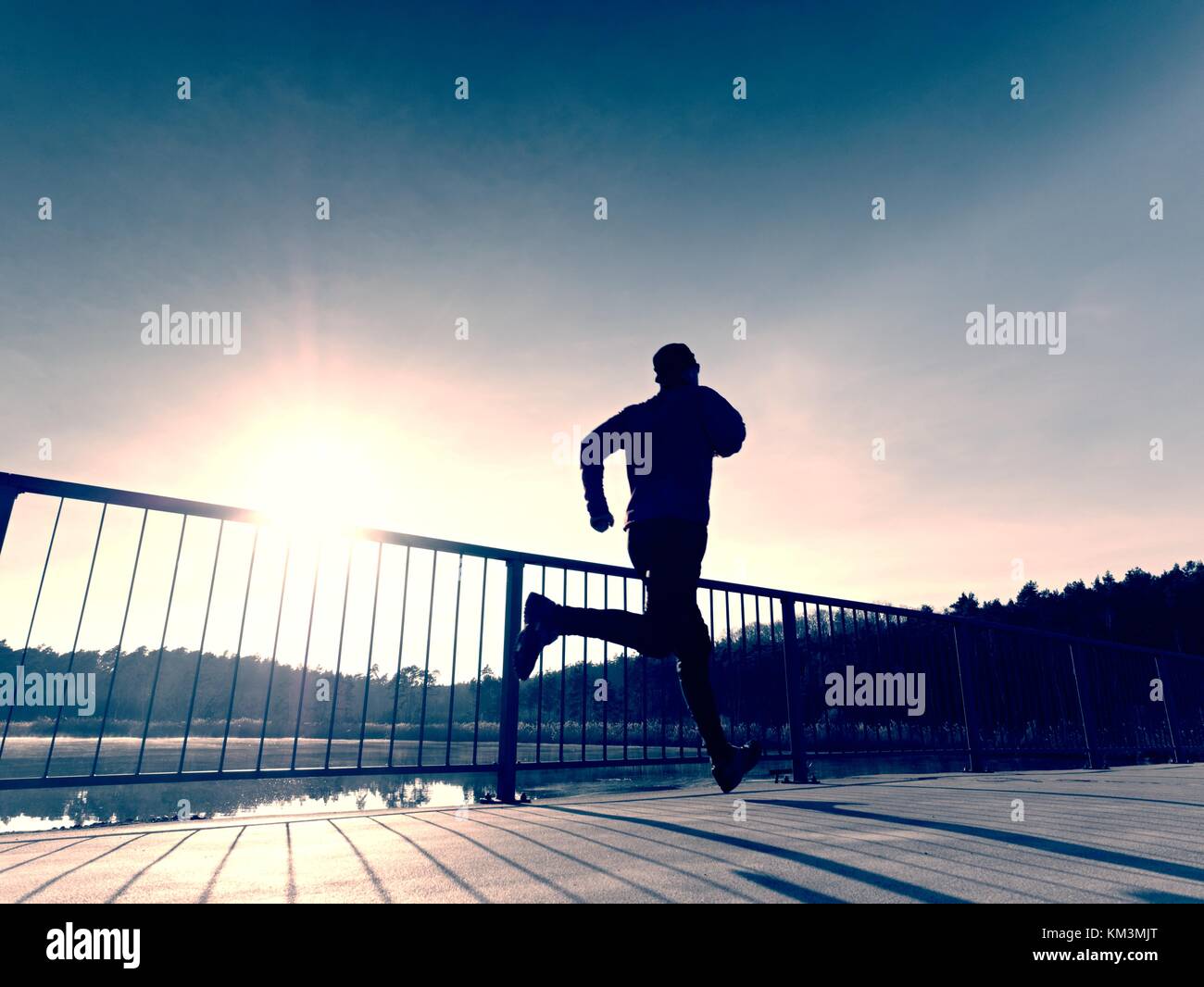 Morning runner in tall black leggings exercising on bridge. Outdoor ...