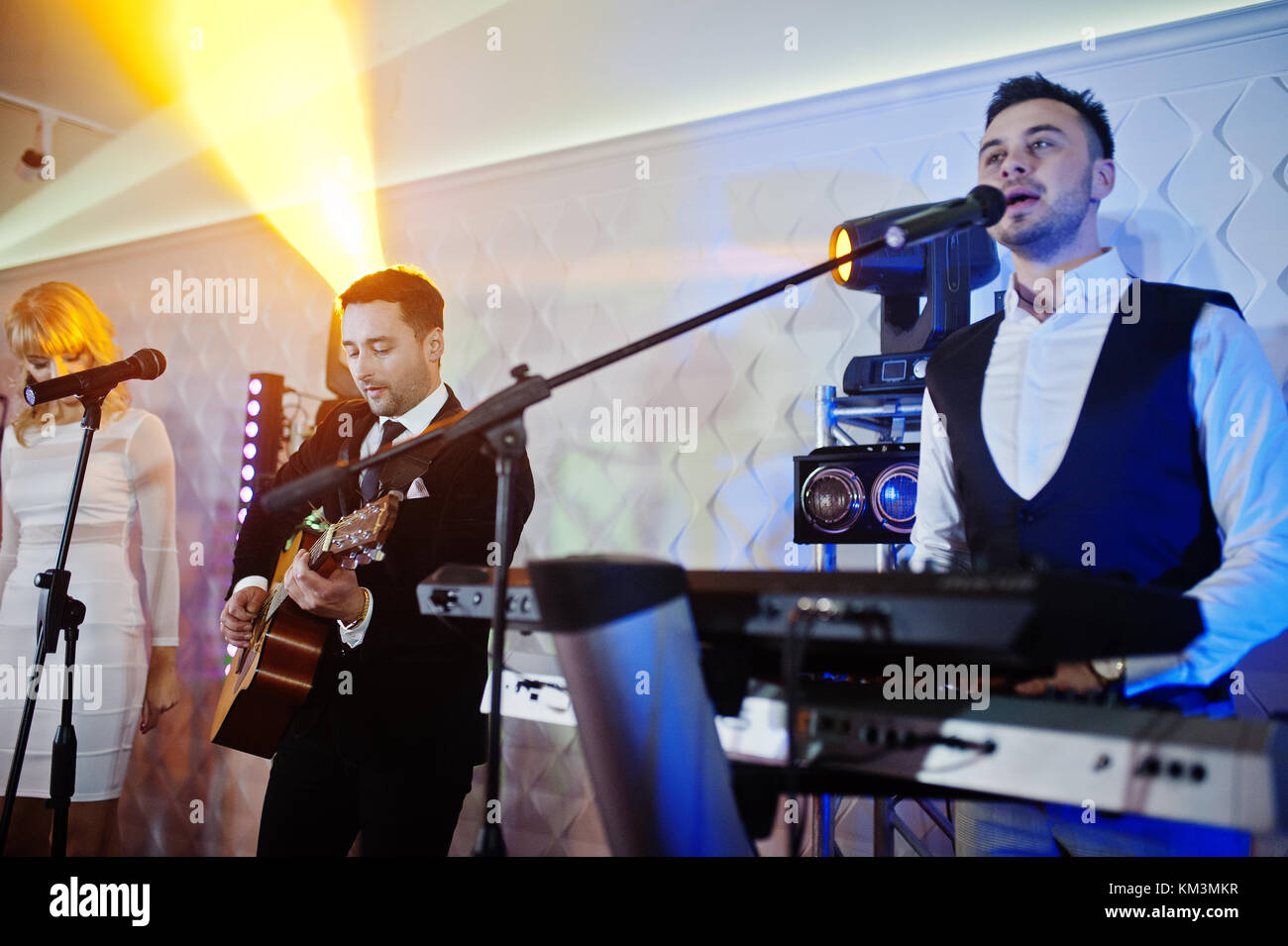 Musicial music live band performing on a stage with different lights ...