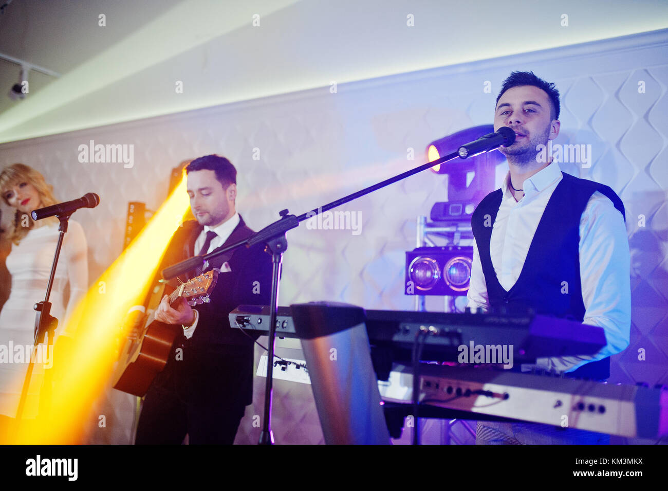 Musicial music live band performing on a stage with different lights ...