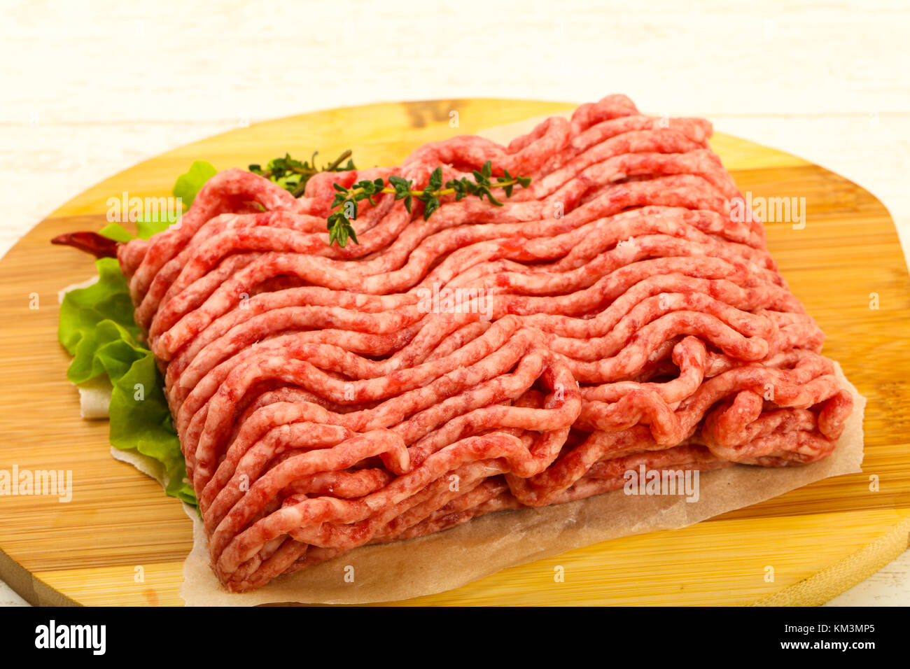 Raw minced beef meat with thyme and hot pepper Stock Photo - Alamy