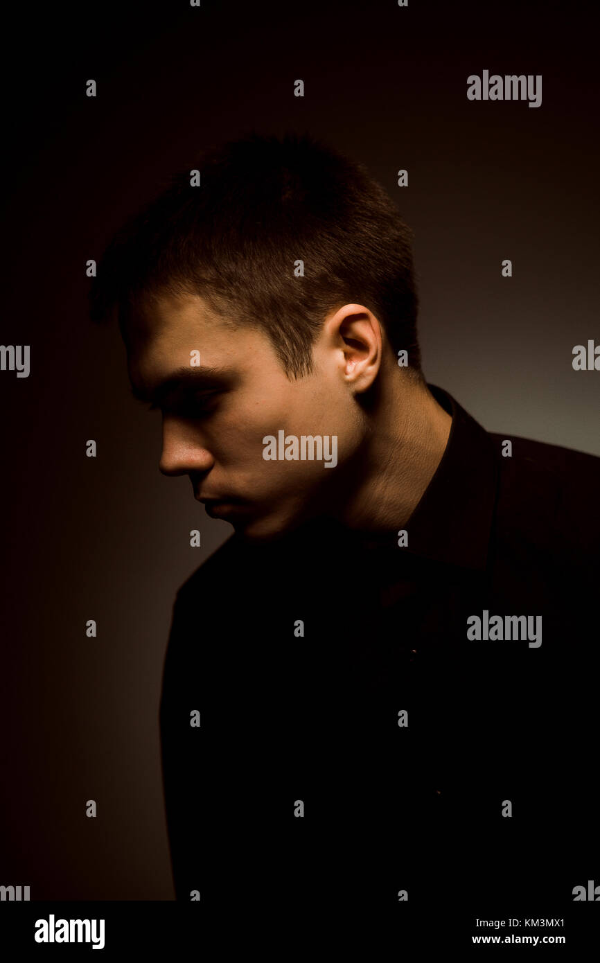 young guy on a dark studio background Stock Photo - Alamy