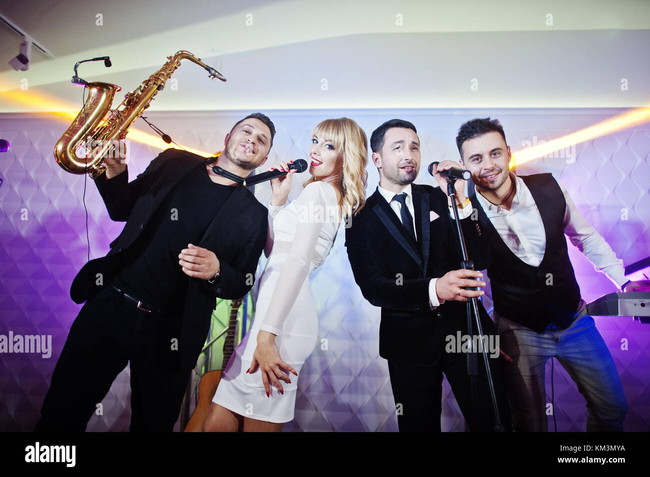 Musicial music live band performing on a stage with different lights ...