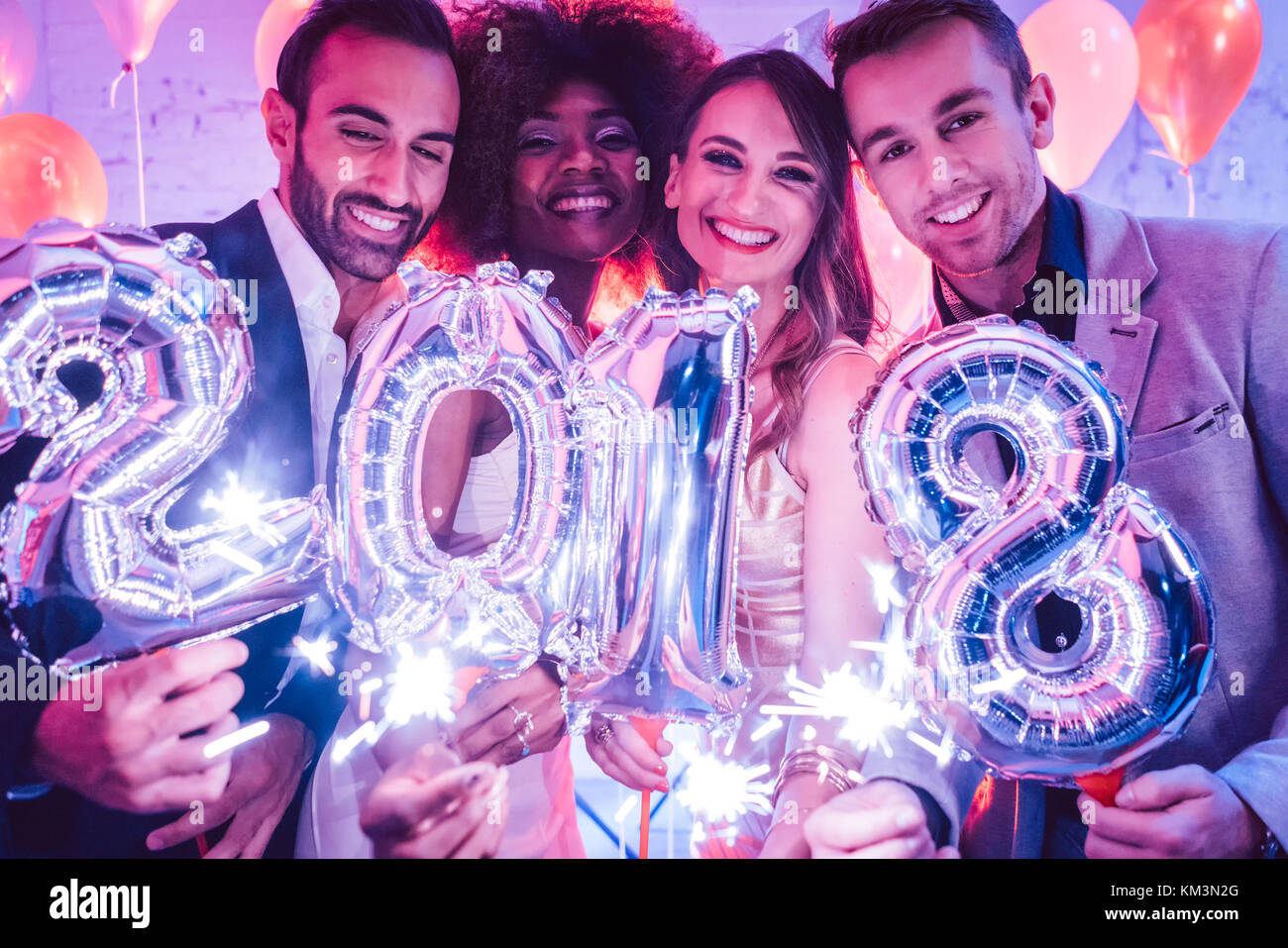 Group of party people celebrating the arrival of 2018, men and women ...
