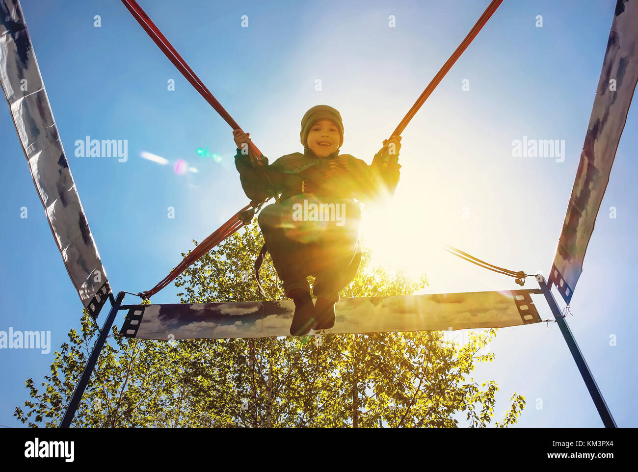 The boy in the time of the jump with a smile, joy and happiness on her ...