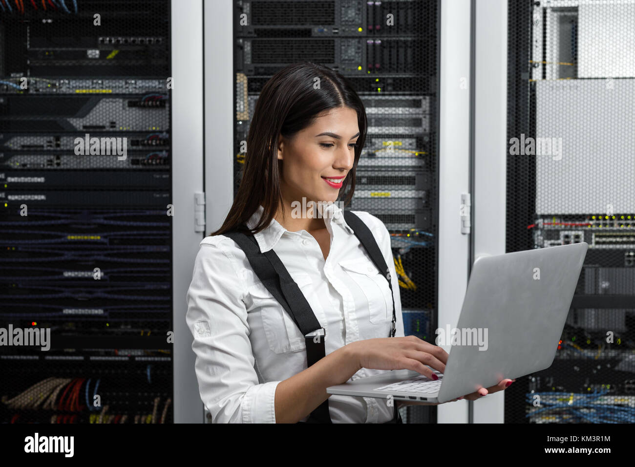 Portrait of technician working on laptop in server room Stock Photo - Alamy