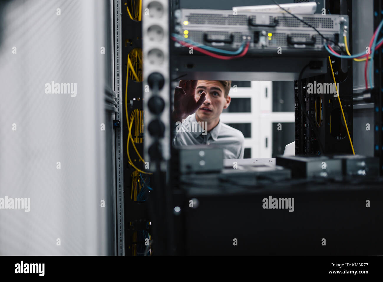 Young business man with laptop working in data center Stock Photo - Alamy
