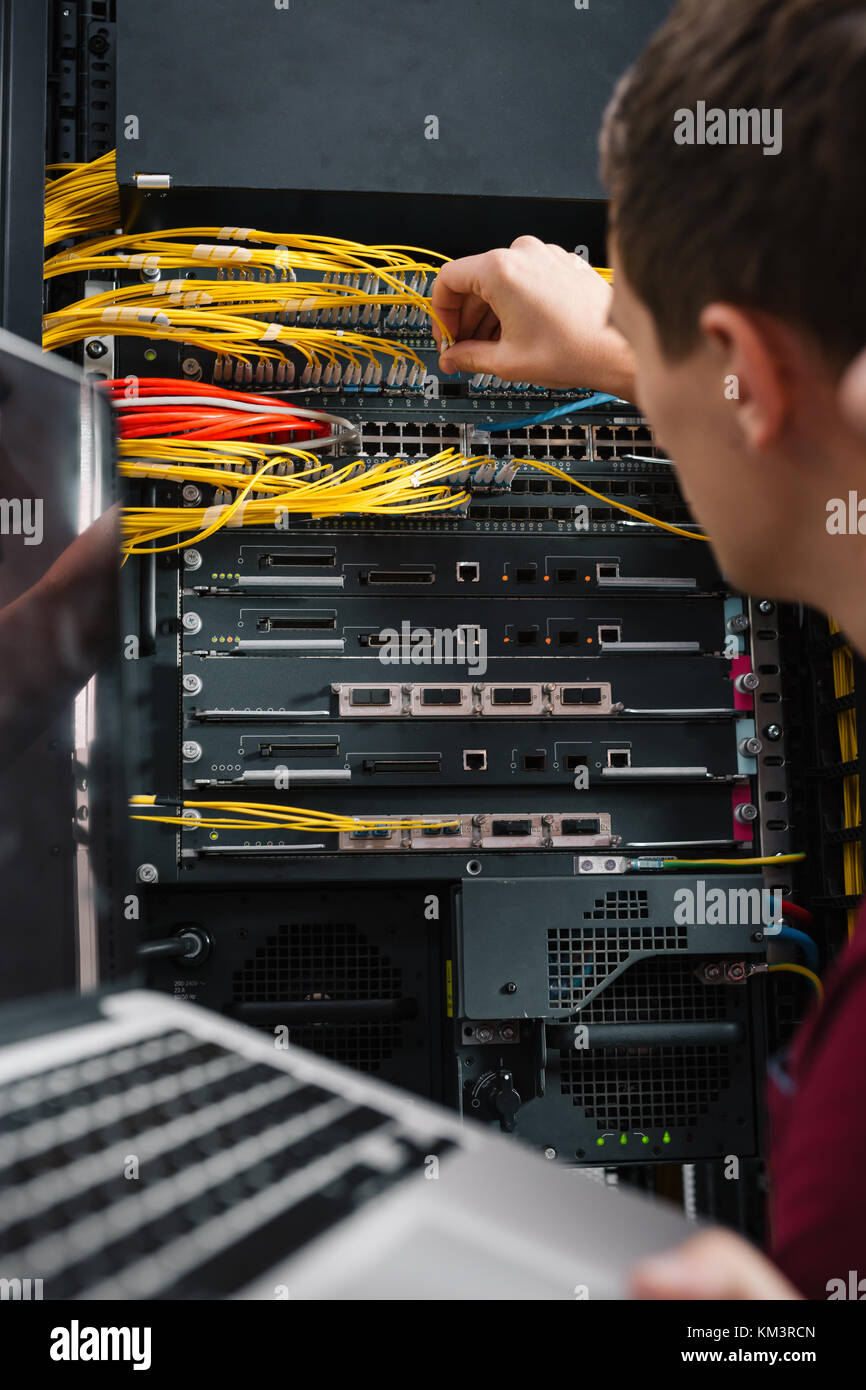 Man fix server network in data center room Stock Photo - Alamy