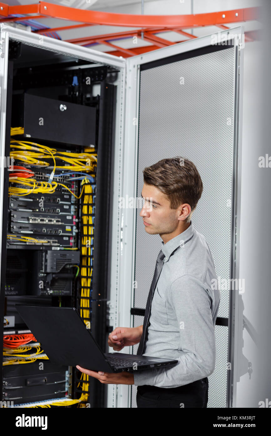 Young business man with laptop working in data center Stock Photo - Alamy