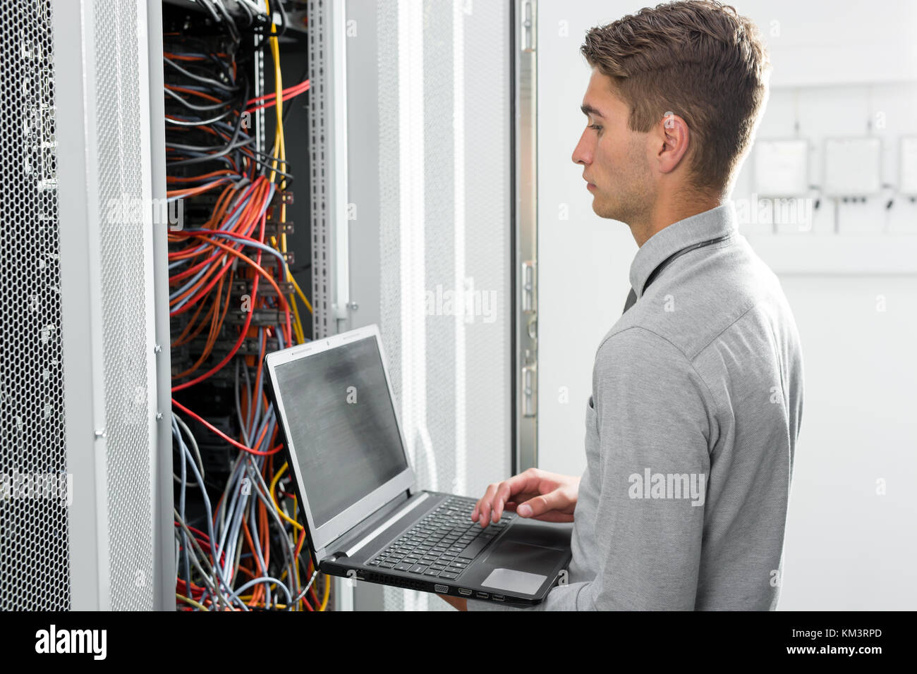 Young business man with laptop working in data center Stock Photo - Alamy