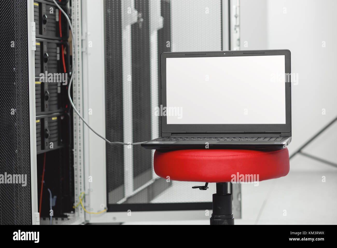 blank displays and laptop in a large server room Stock Photo - Alamy