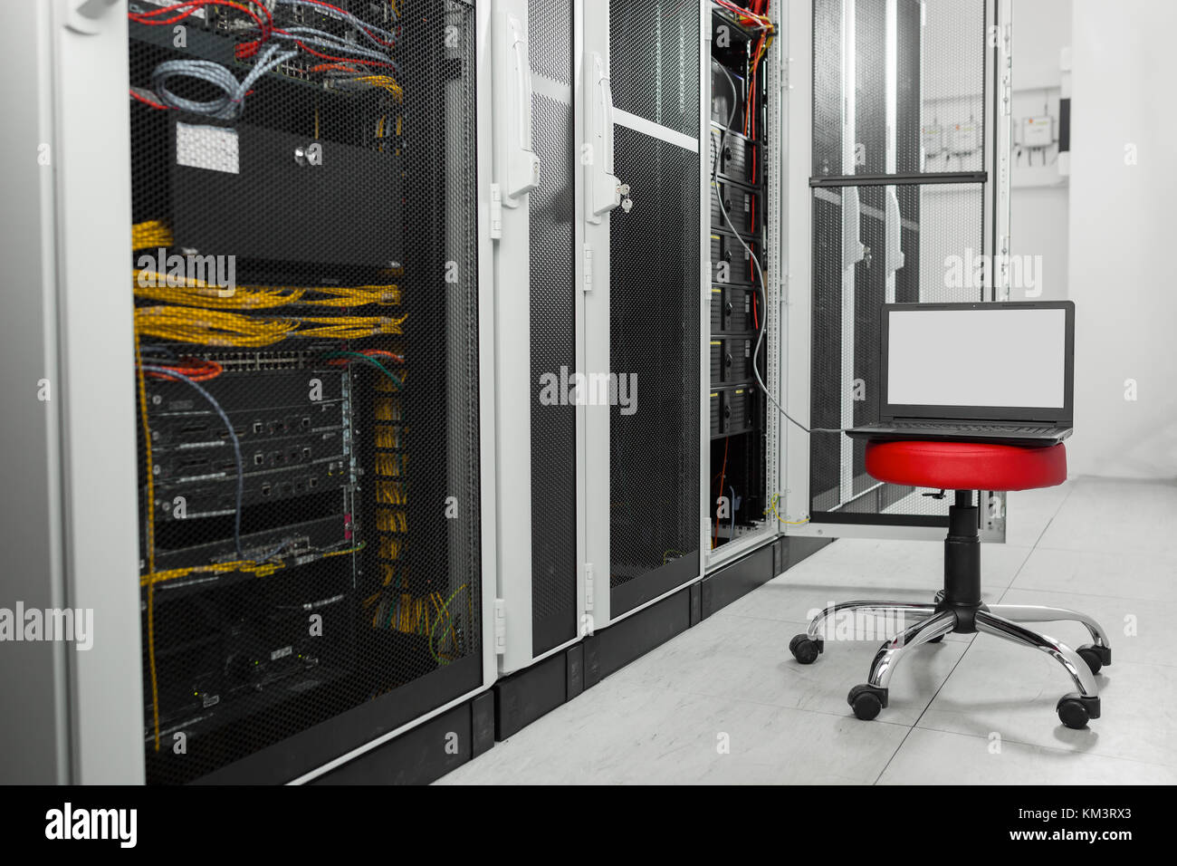 blank displays and laptop in a large server room Stock Photo - Alamy