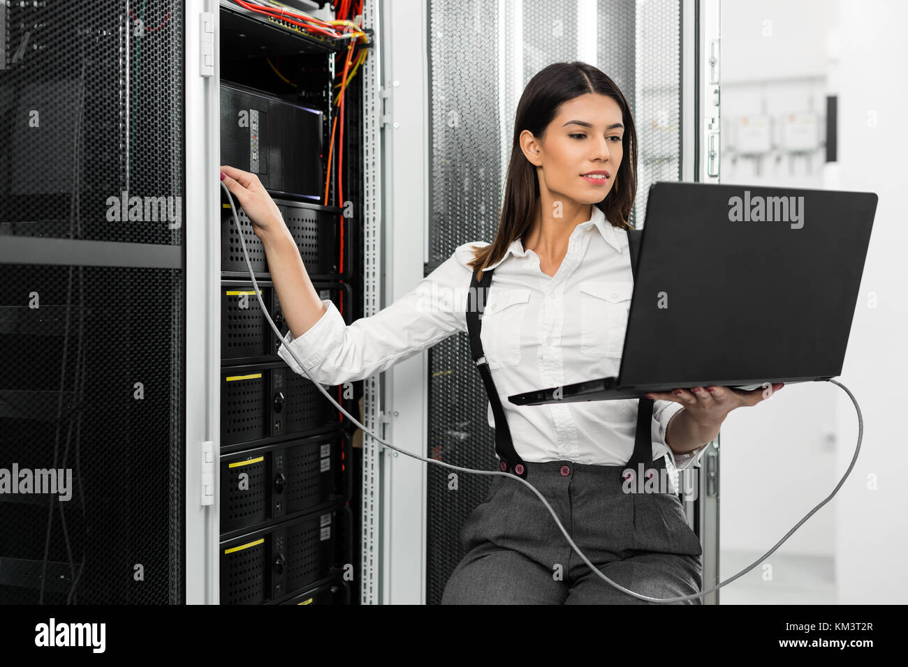 Portrait of technician working on laptop in server room Stock Photo - Alamy