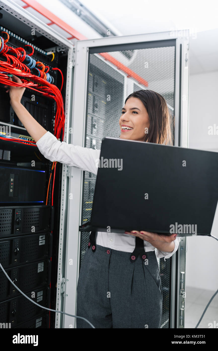Portrait of technician working on laptop in server room Stock Photo - Alamy