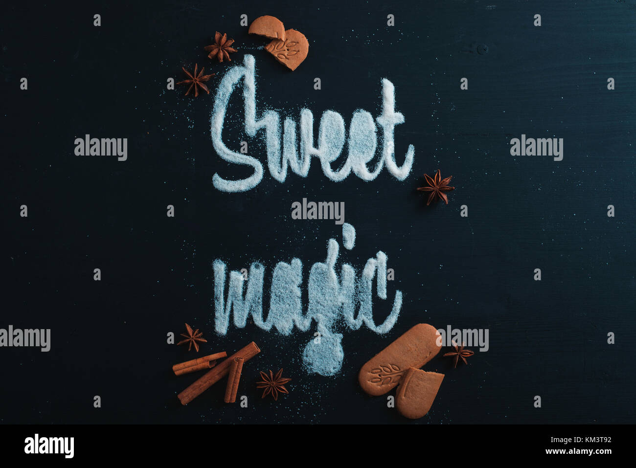 Words Sweet Magic made with sugar. Cookies and crumbs on a dark ...