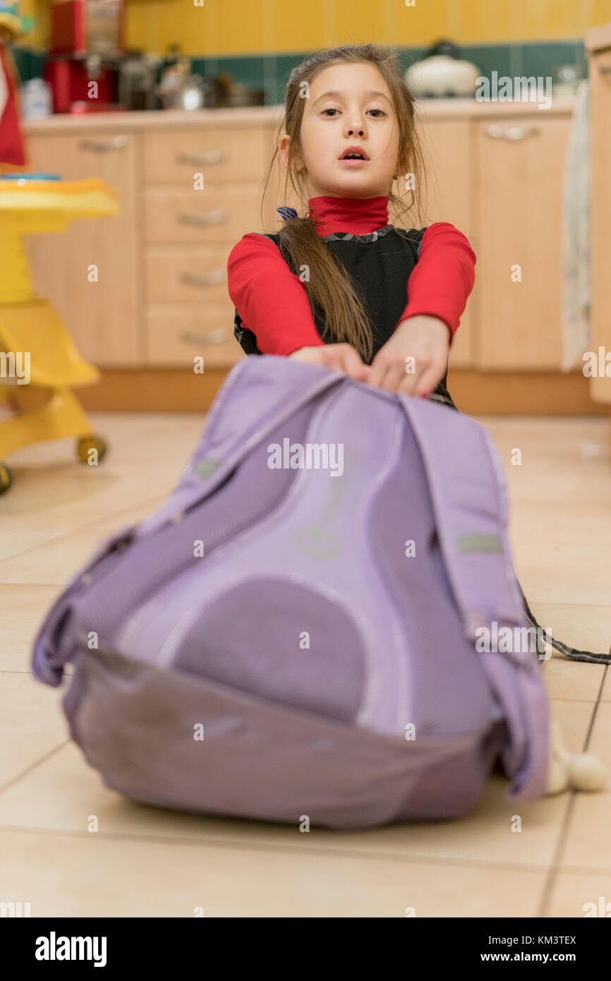 sweet beautiful little schoolgirl tired and exhausted carrying on her ...