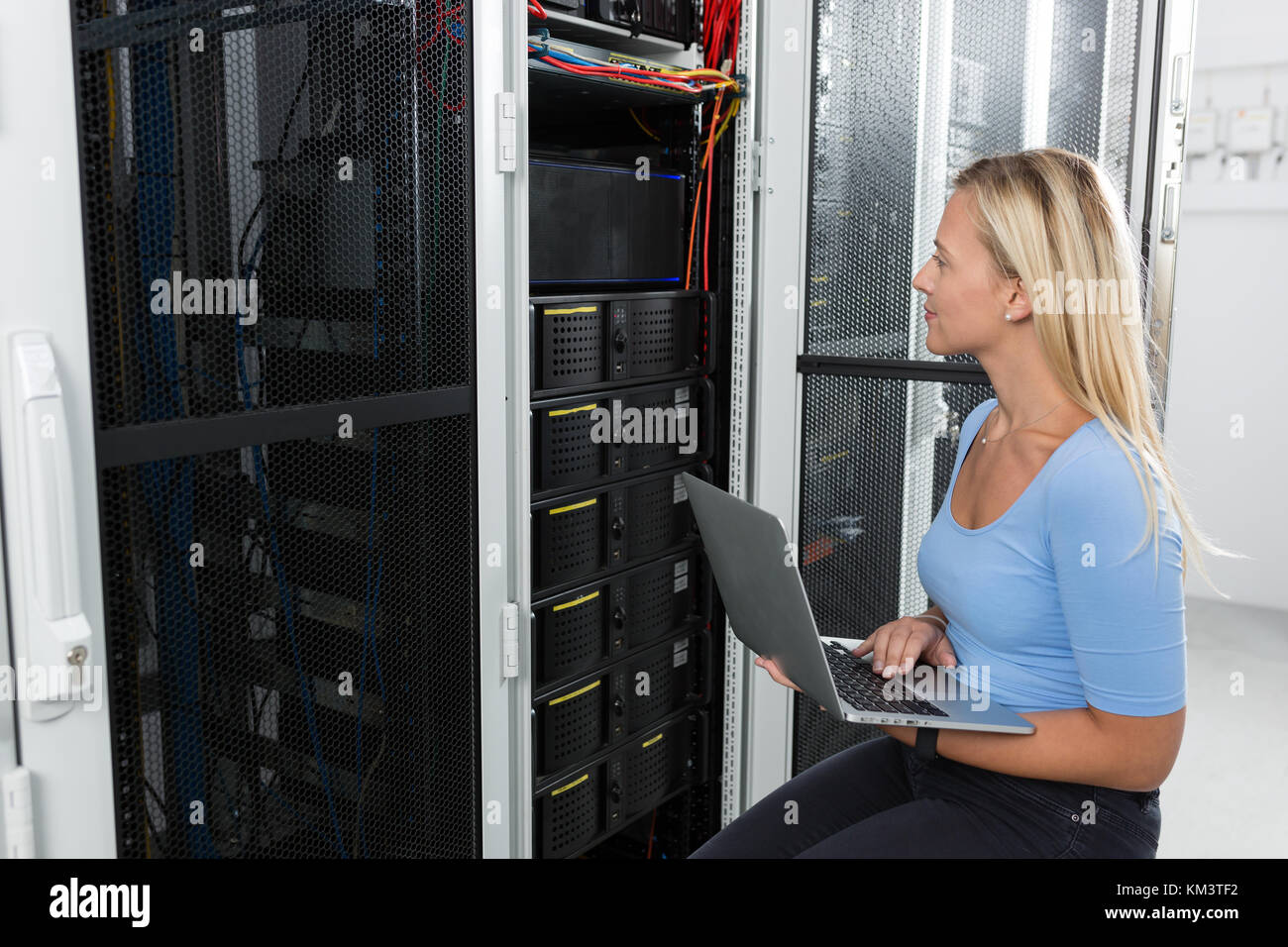 Portrait of technician working on laptop in server room Stock Photo - Alamy