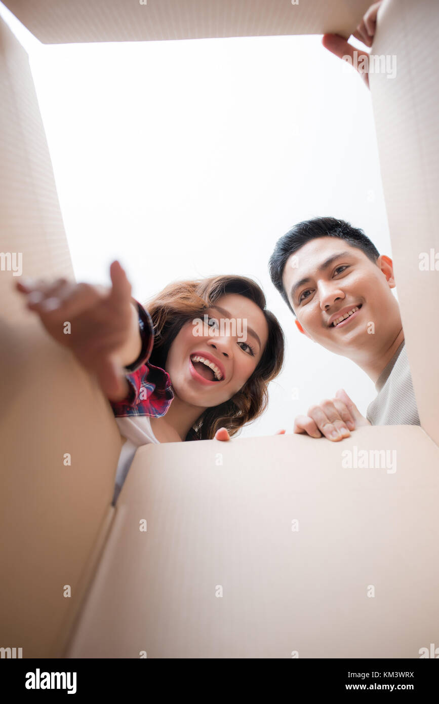 Young asian couple looking into the box Stock Photo - Alamy