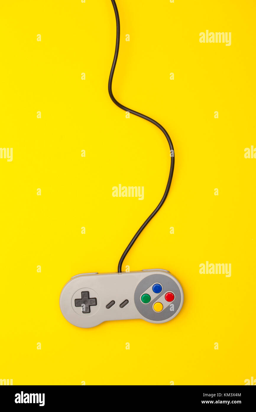 Retro computer gaming controller on a bright yellow background Stock ...