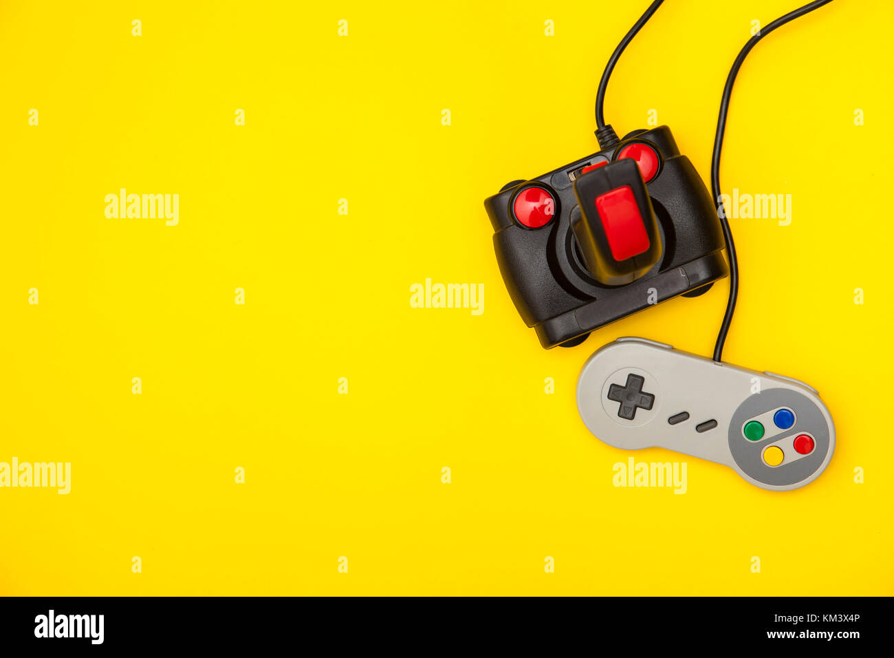 Retro computer gaming controllers on a bright yellow background Stock ...