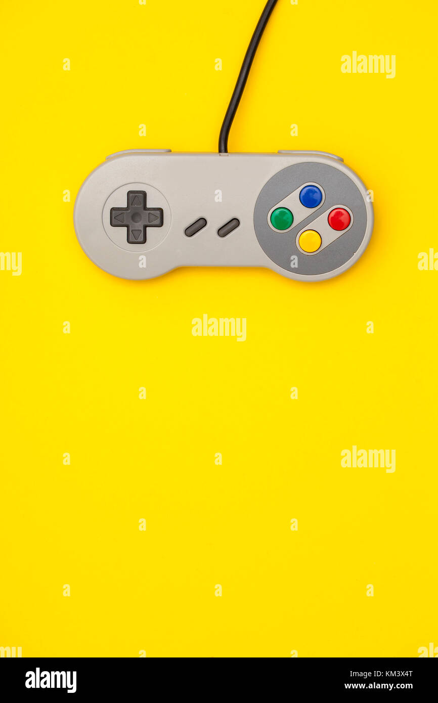 Retro computer gaming controller on a bright yellow background Stock ...
