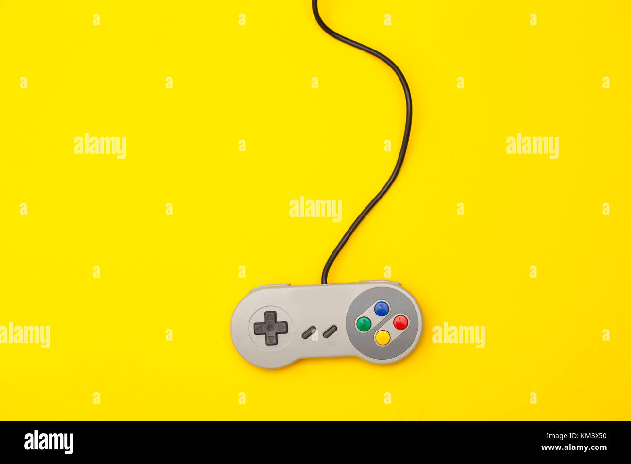 Retro computer gaming controller on a bright yellow background Stock ...