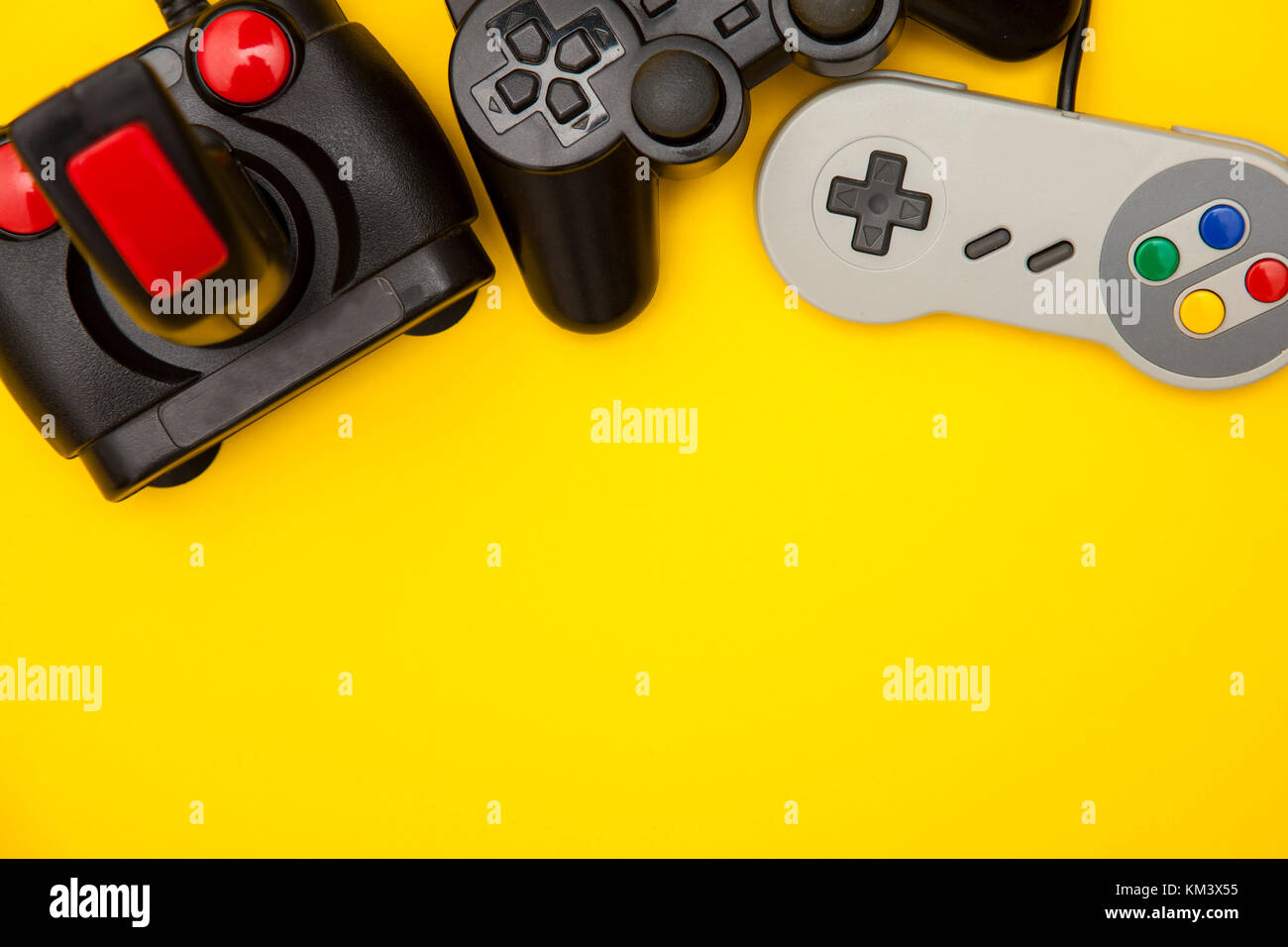 Retro computer gaming controllers on a bright yellow background Stock ...