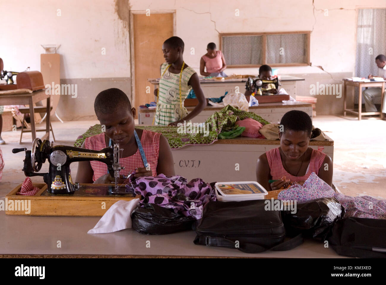 Girls working on a sewing machine learning tailoring crafts, sewing ...