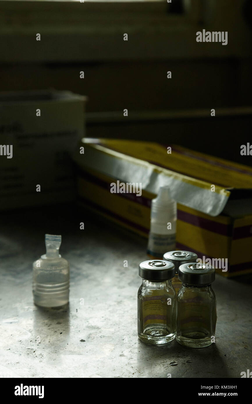 Used injection bottles lie in a pile in a village clinic in Papua New ...