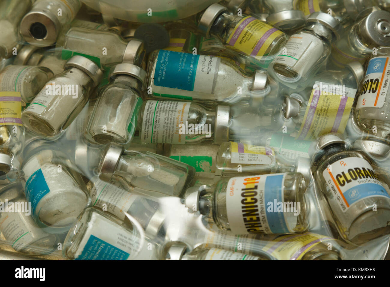 Used injection bottles lie in a pile in a village clinic in Papua New ...