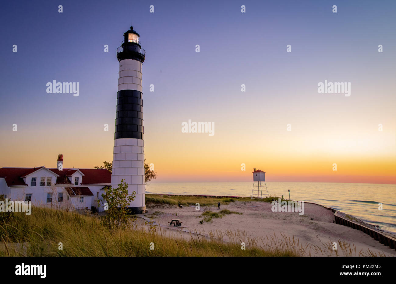 Lighthouse Beach Sunset Background. Illuminated Big Sable lighthouse ... Lighthouse Beach Sunset Background. Illuminated Big Sable lighthouse ...