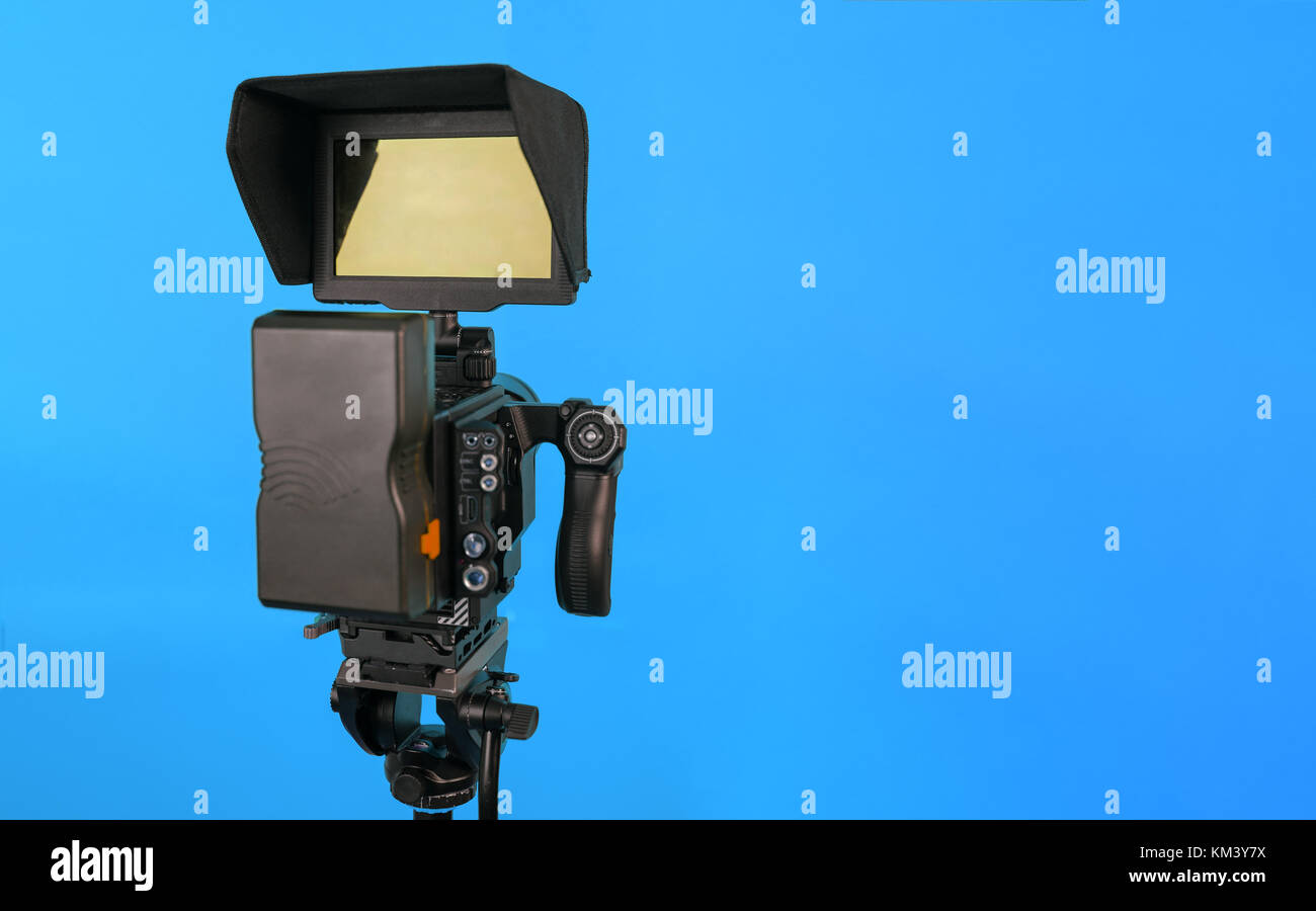 Professional video camera on vivid color background making contrast ...