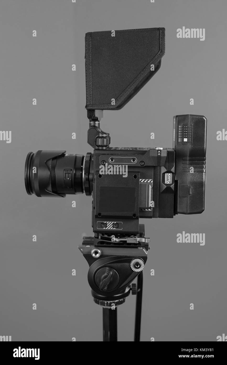 Professional video camera on vivid color background making contrast ...