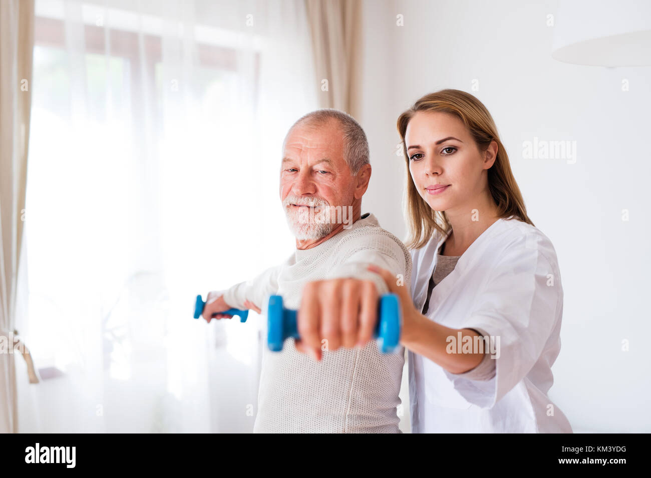 Health visitor and senior man during home visit Stock Photo - Alamy