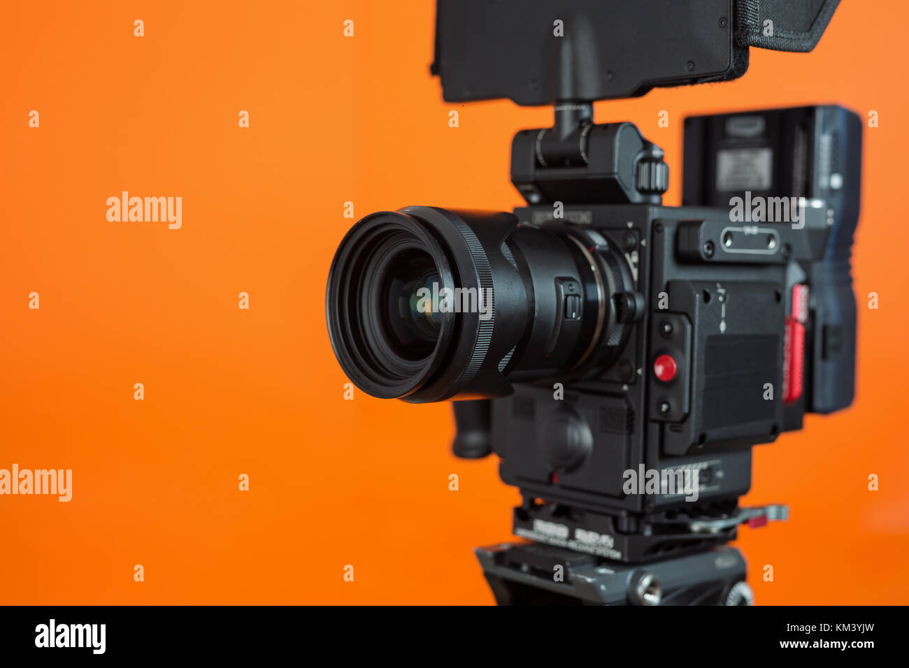 Professional video camera on vivid color background making contrast ...