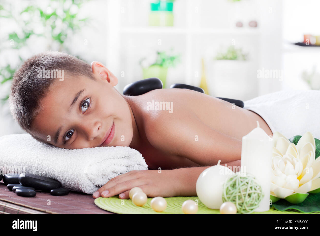 young boy relaxing in spa salon with spa stone Stock Photo - Alamy