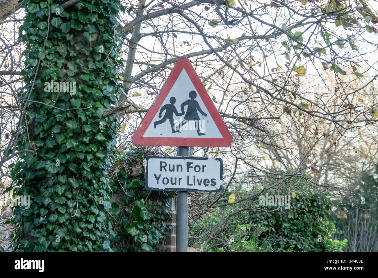 Children Crossing warning street sign with added unoffical sign with ...