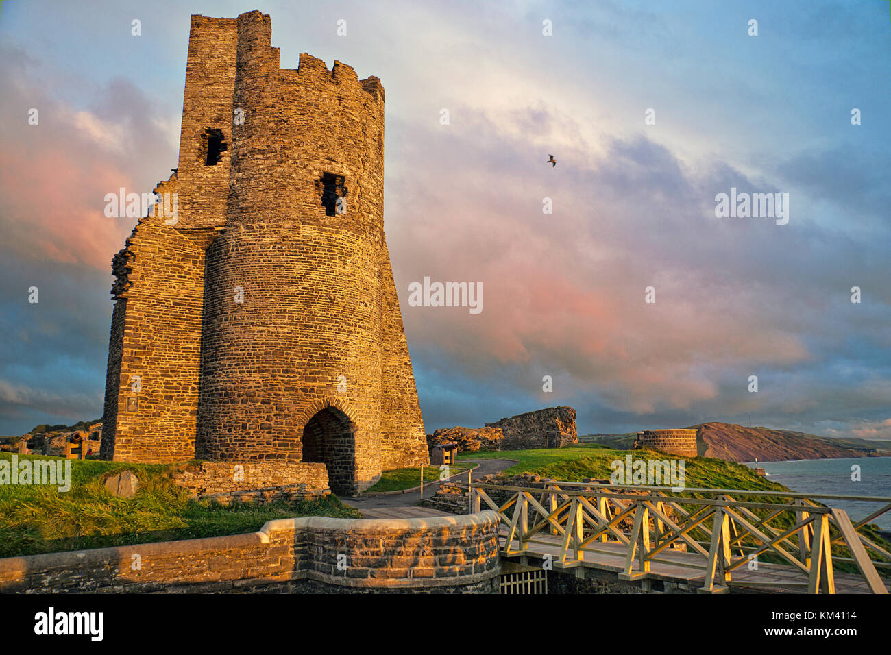 The remains of the ruined castle in golden hour light. It was built in ...