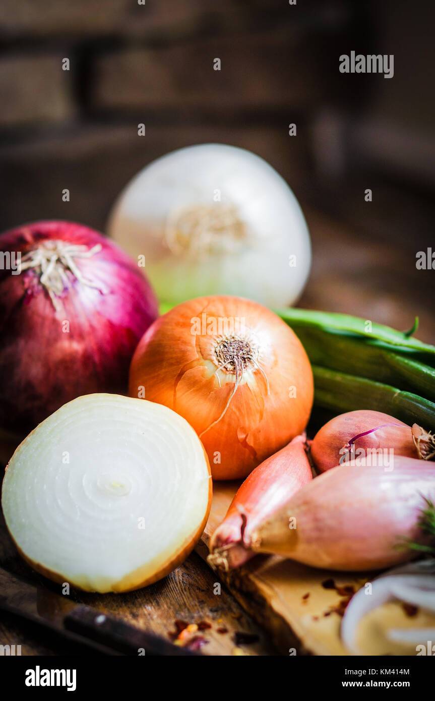 Colorful Onions On Rustic Wooden Background Stock Photo - Alamy